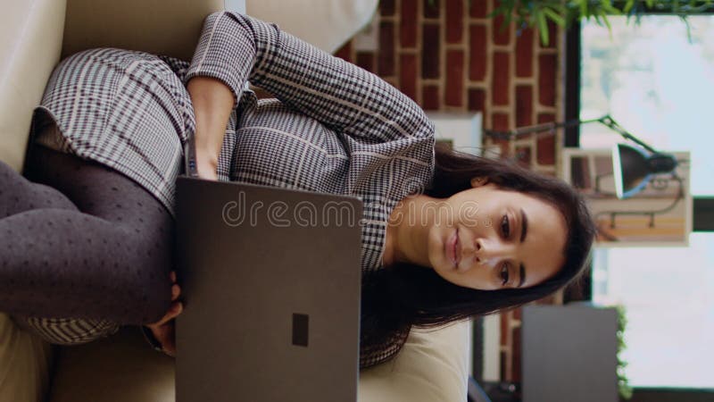 Vertical Video Teleworker Lying on Couch, Remotely Performing Tasks in ...