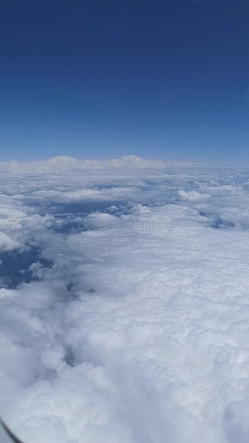 Vertical Video of a View from a Plane Window, Showing Mountains and ...