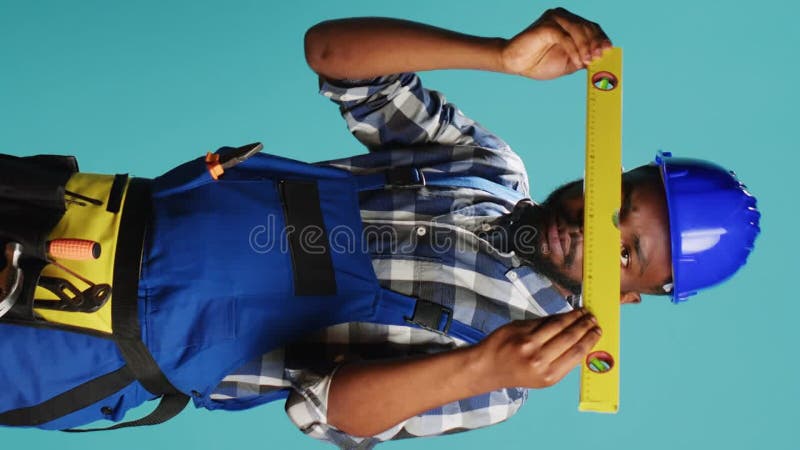 Vertical Video: Young Adult Measuring Surface with Bench Level Tool ...