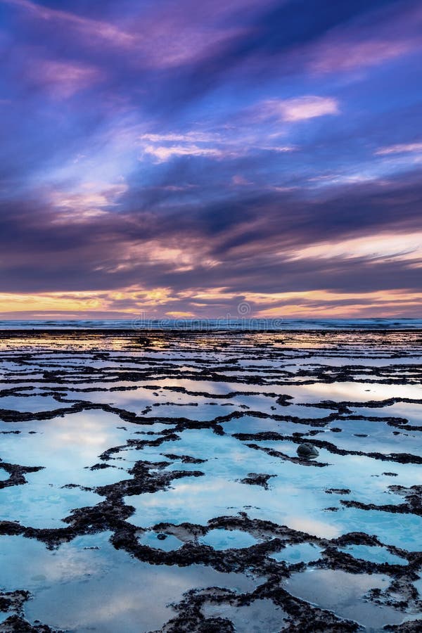 Vertical Ocean Coast and Beach Landscape with Small Sailboat Under a ...