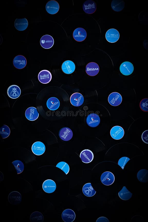 Vertical View of Blue Circle Stickers of Different Logos on the Black ...