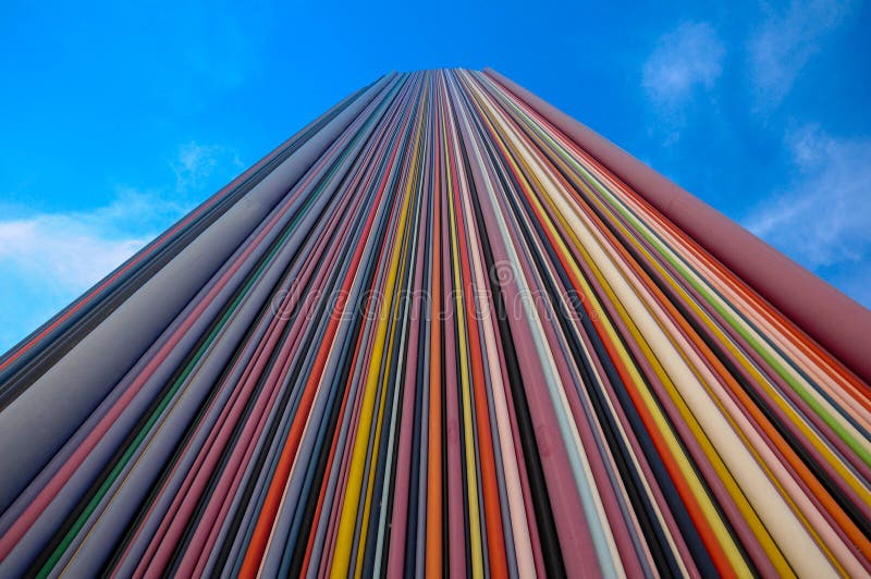 Vertical View of Colorful, Striped Skyscraper Against a Clear Blue Sky ...