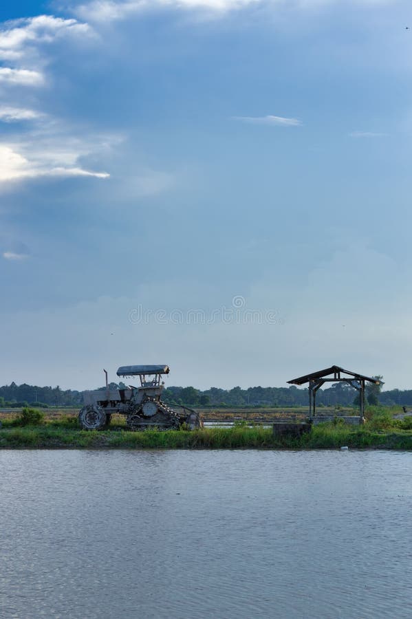 Vertical View of a Farming Machine by the Water Under the Blue Sky ...