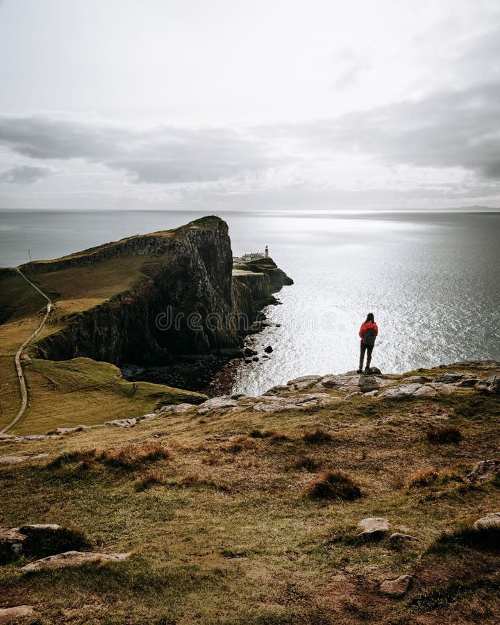 Vertical View of a Human Standing on the Edge of the Coast Enjoying the ...