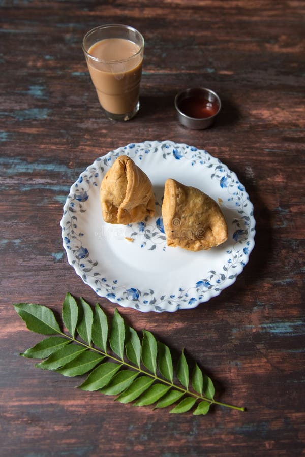 Vertical View of Indian Snack Samosa and Tea Along with Condiments ...