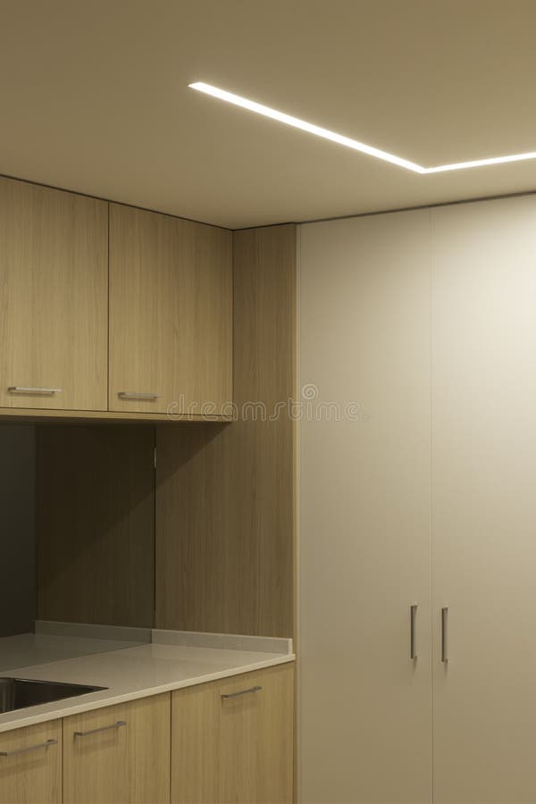 Vertical View of Modern Minimal Wood and White Kitchen Illuminated ...