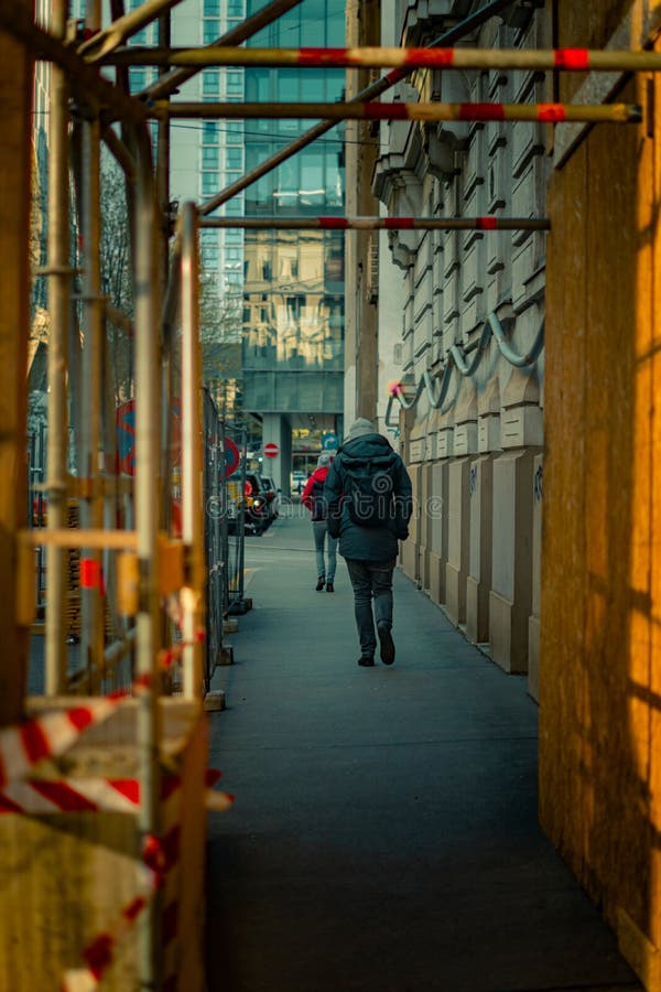 Vertical View of People Walking on a Pavement Shot from Behind Stock ...