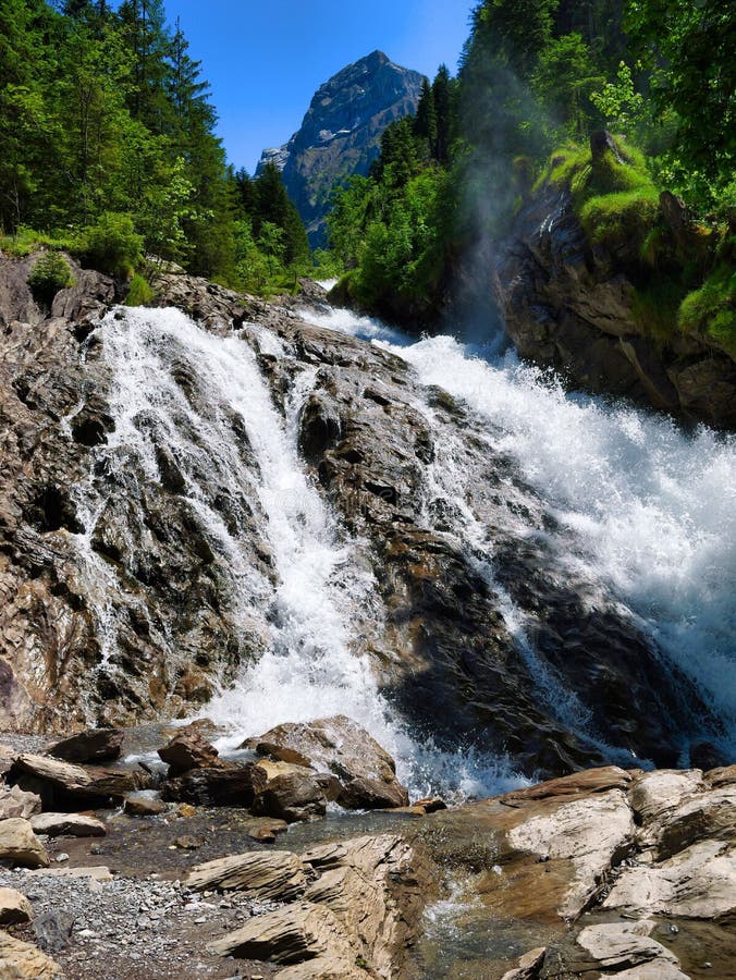 Vertical View of a River Falling Down a Rocky Slope in the Forest Under ...