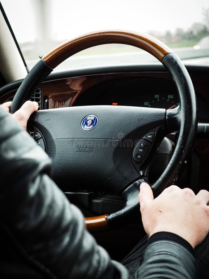 Vertical View of a Saab Driver S Hands Holding the Steering Wheel ...