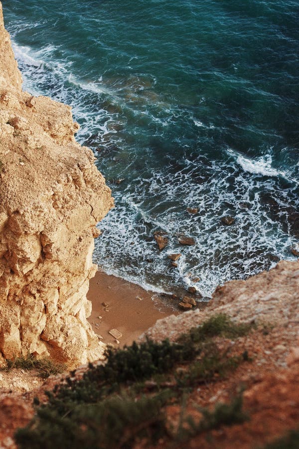 Vertical View from Seaside Steep Cliffs of Sea Waves Crashing into ...