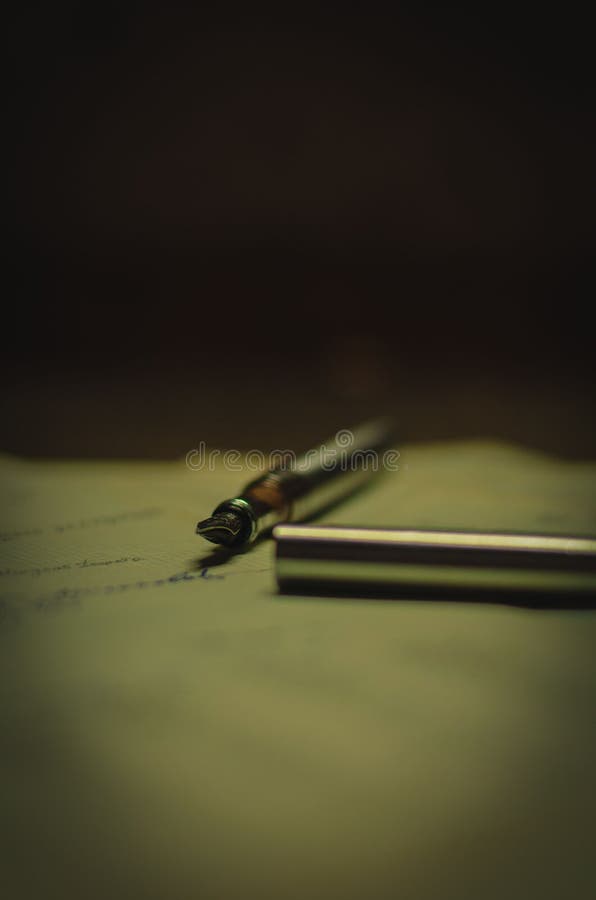 Vertical View of a Silver Fountain Pen Over the Handwritten Paper ...