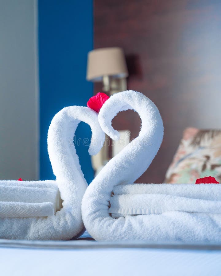 Vertical View of Swans Made of White Towels - Decorated Bed for Couples ...