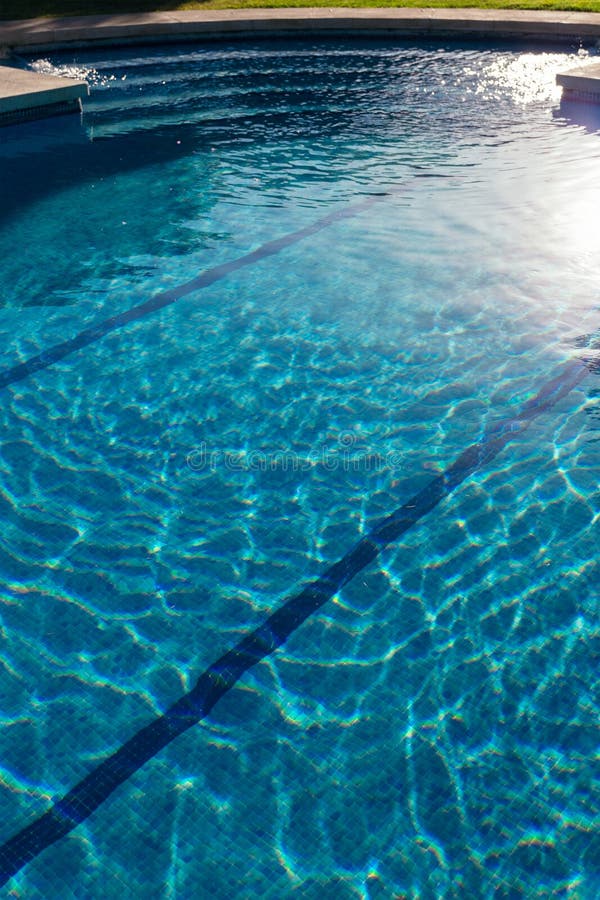 Vertical View of a Swimming Pool with Turquoise Water and Reflections ...