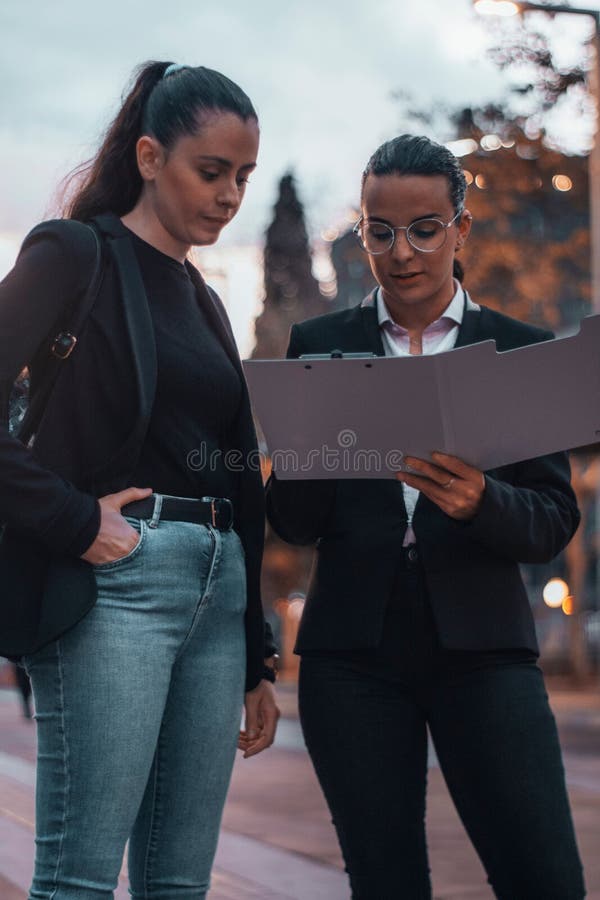 Vertical View of Two Female Students Checking on a Task while Standing ...