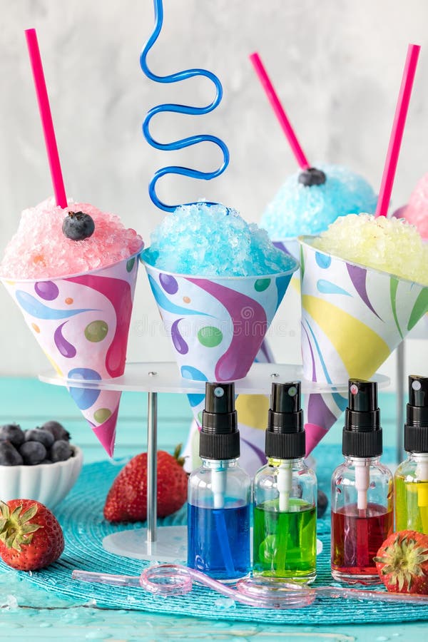 A Vertical View of Various Snow Cones with Flavoured Syrups in Front ...