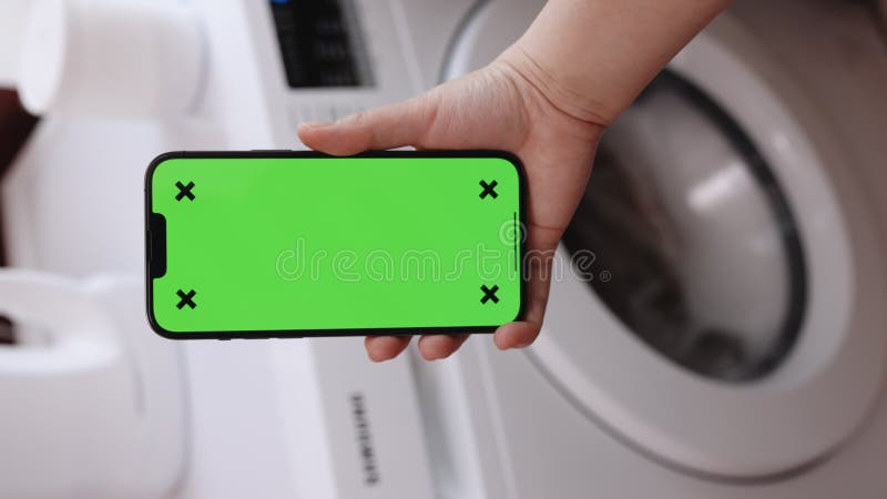 Vertical View of Woman Using Digital Smart Phone on Laundry during ...