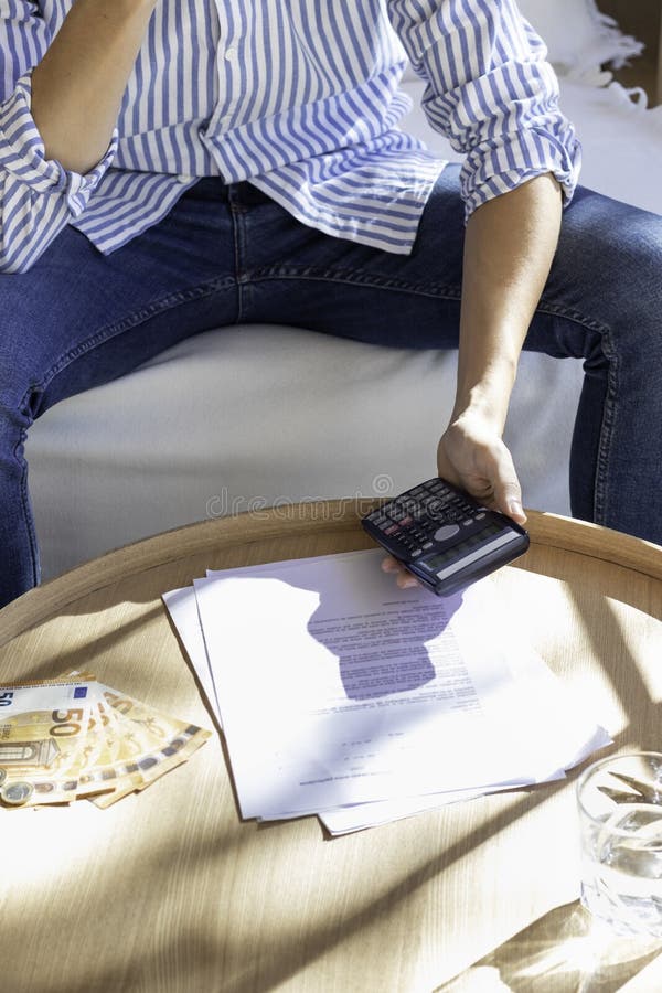 Vertical View of Young Man Making Calculations about the Contract and ... Vertical View of Young Man Making Calculations about the Contract and ...