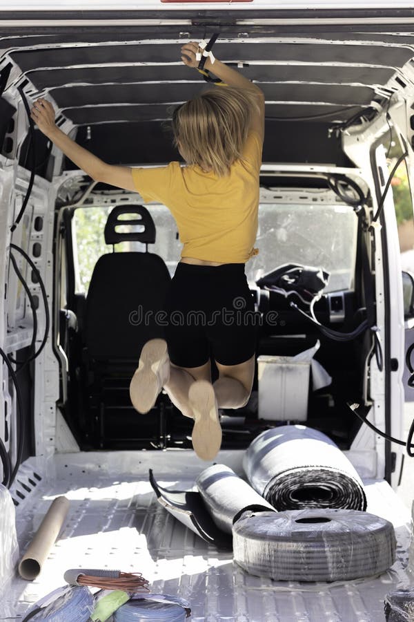 Vertical View of Young Woman from the Back Jumping Inside a Camper Van ...