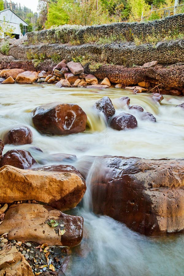 Vertical of Waterfalls through Red Rocks in Urban Area Stock Image ...