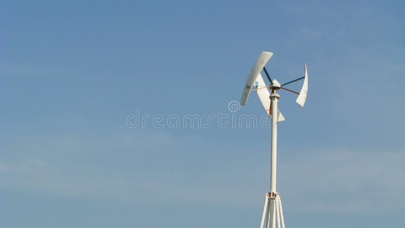 Vertical Wind Turbine on Grassy Yellow Farm Canola Field Against Cloudy ...
