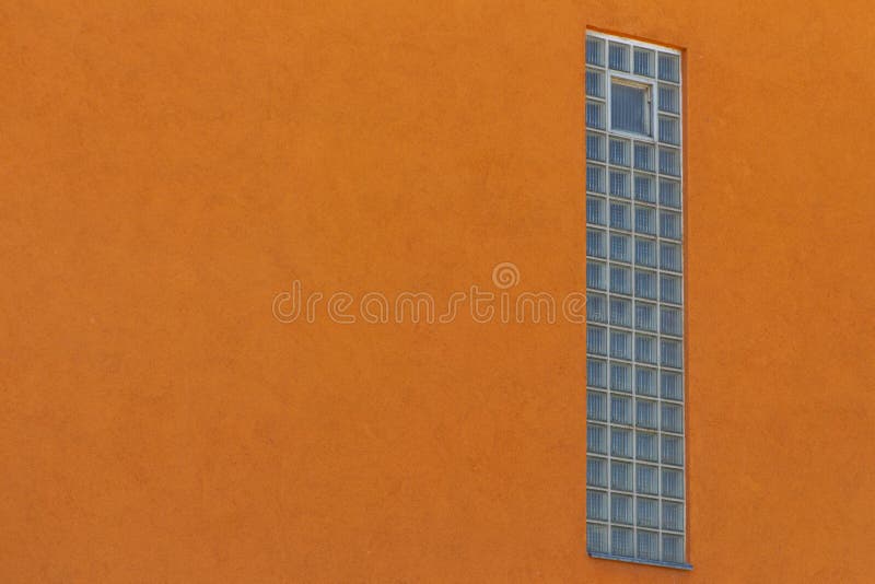 Vertical Window Build with Glass Blocks in a Orange Wall Stock Image ...