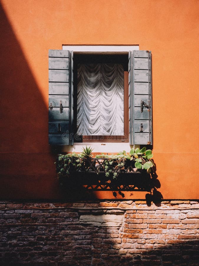 Vertical of a Window of an Old Orange Building in Venice, Italy Stock ...