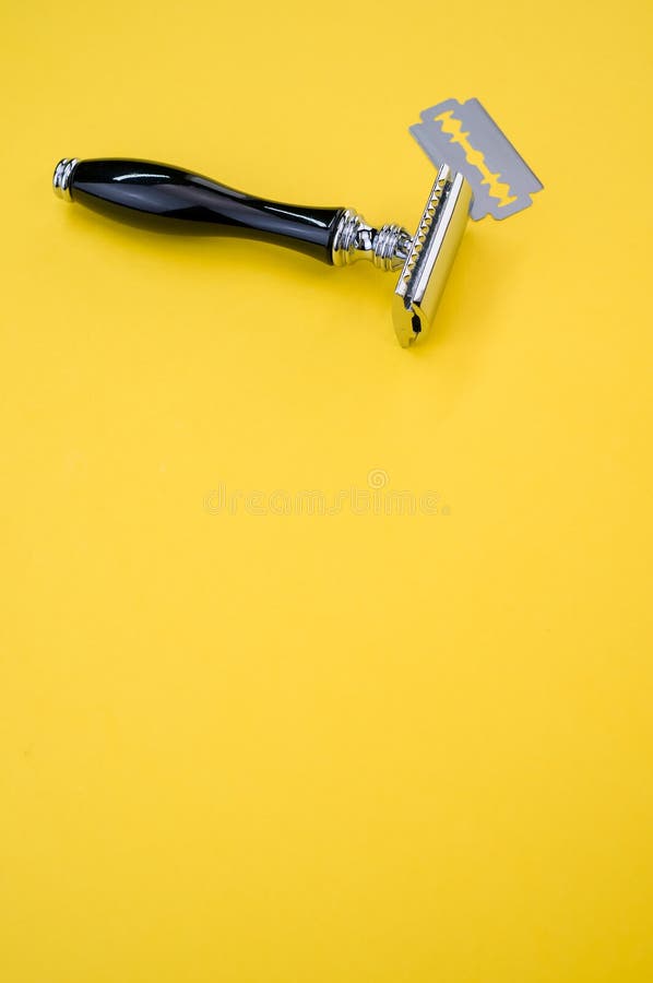Vertof a Mechanical Razor and Blade Isolated on Yellow Background Stock ...