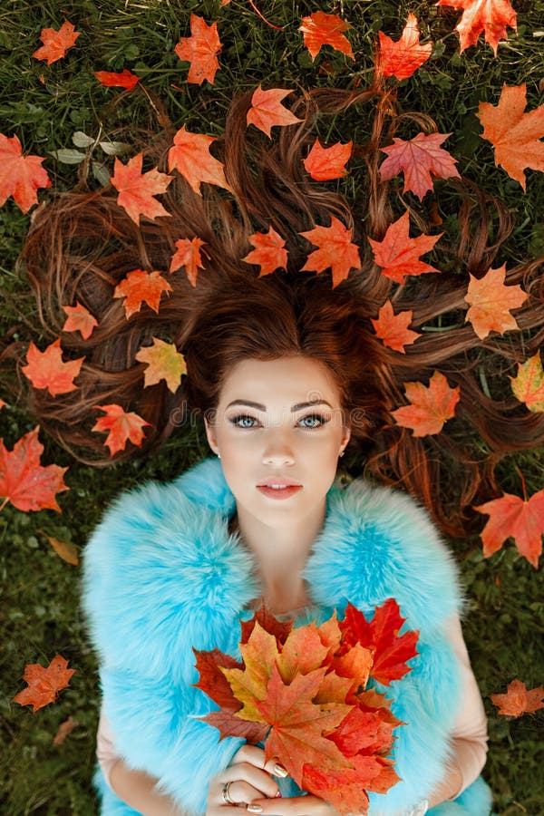 Very Beautiful Young Brunette Woman Lies On The Grass Her Orange Maple
