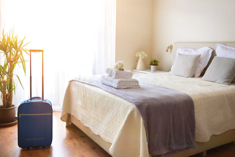 Very Bright Hotel Room with Clean White Towels and Suitcase Stock Photo ...