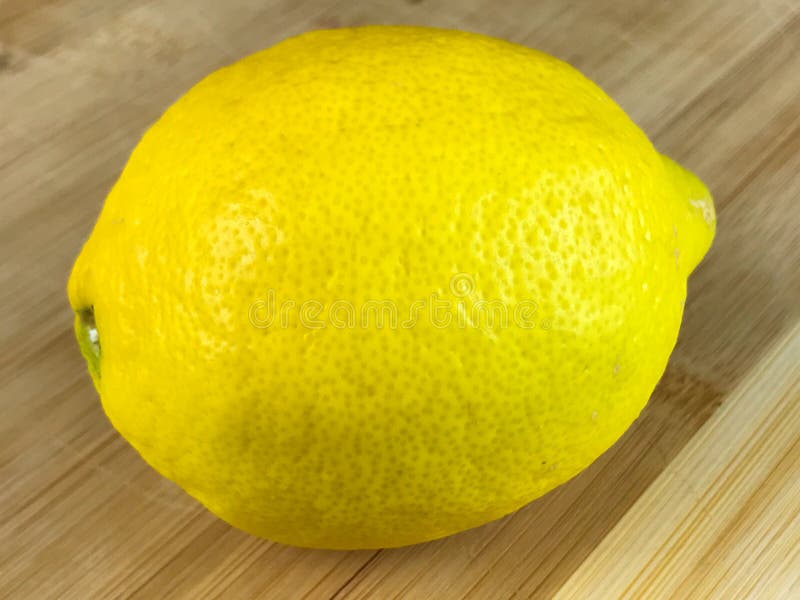 One Fresh Lemon on a Cutting Board Stock Photo - Image of flavor, fresh ...