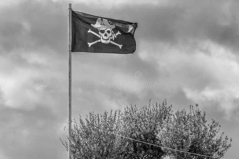 A Funny Pirate Flag Against the Cloudy Sky in Black and White Stock ...