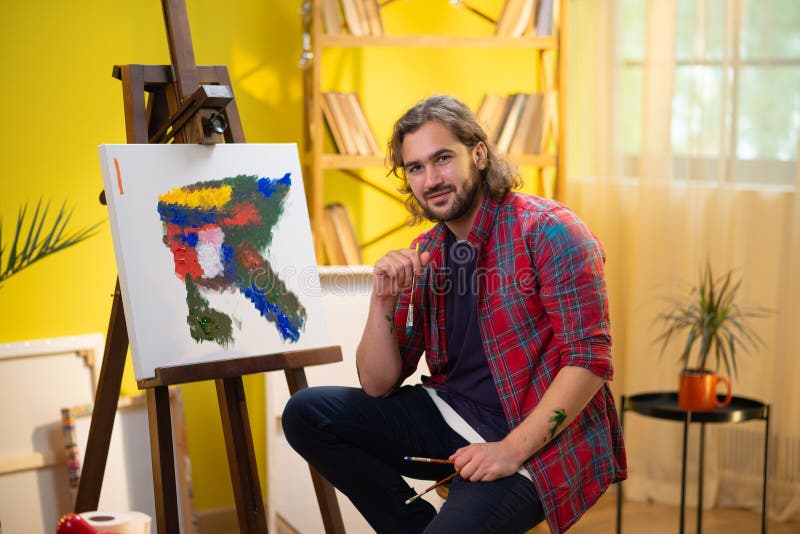 A Very Handsome Painter Man is Standing in Front of His Painting and ...