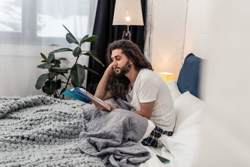 Nice Thoughtful Man Looking into the Book Stock Photo - Image of adult ...