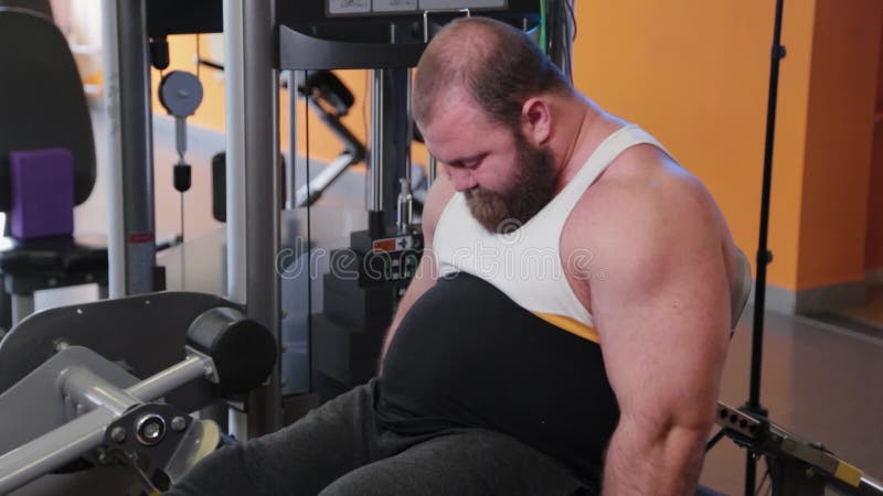 Very Large Bearded Bodybuilder Trains Legs in the Gym. Stock Footage ...