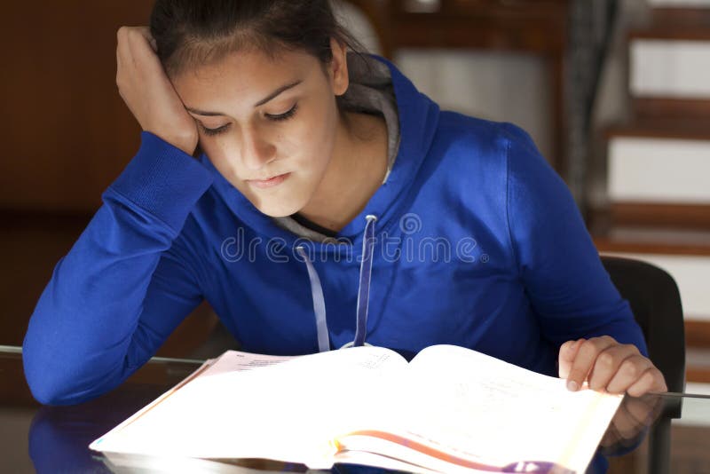 Very Listless Girl Reluctantly Studying a Textbook Stock Image - Image ...