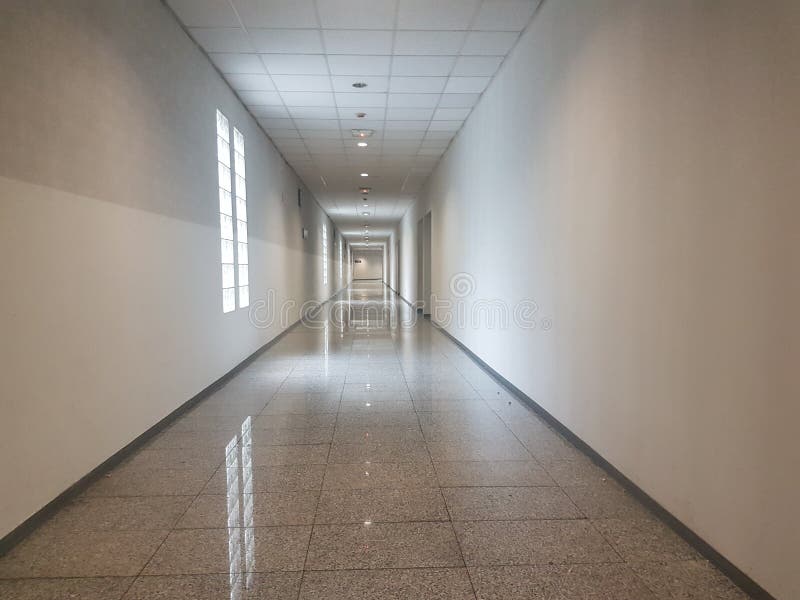 Very Long Corridor with Windows and Door Stock Photo - Image of walls ...