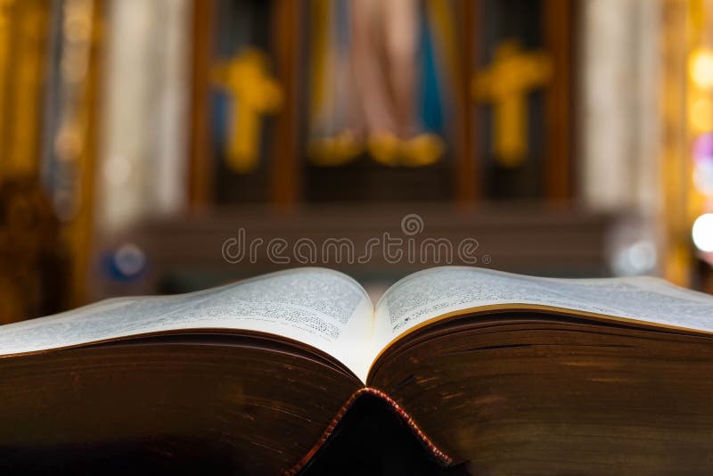 Ancient Bible with a Soft Focus Catholic Christian Alter in the ...