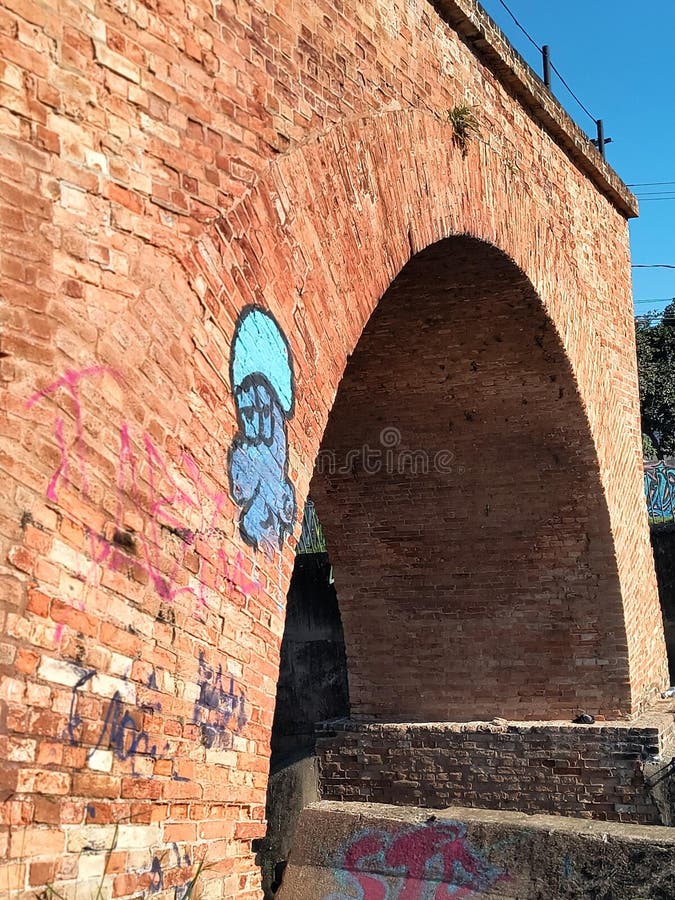 A Very Old Brick Arch Bridge in a City with Graffiti Stock Image ...