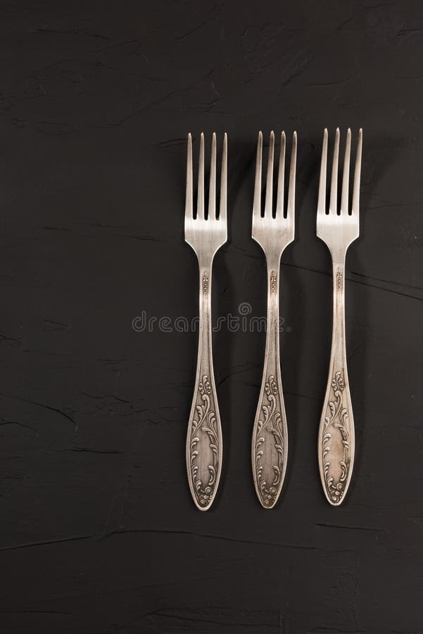 Very Old Set of Three Rusty Vintage Silver Forks on a White Cement ...