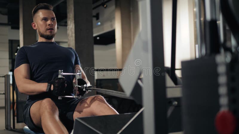 Very Power Athletic Guy Bodybuilder, Execute Exercise with Gym Machine ...