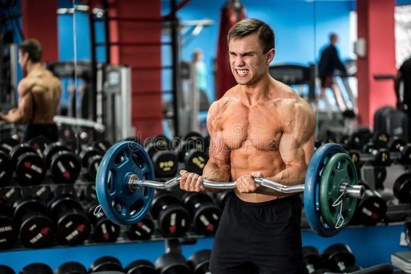 Very Power Athletic Guy Standing Workout in the Gym. Stock Photo ...