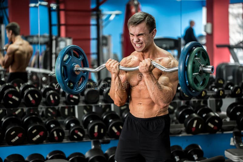 Very Power Athletic Guy Standing Workout in the Gym. Stock Photo ...