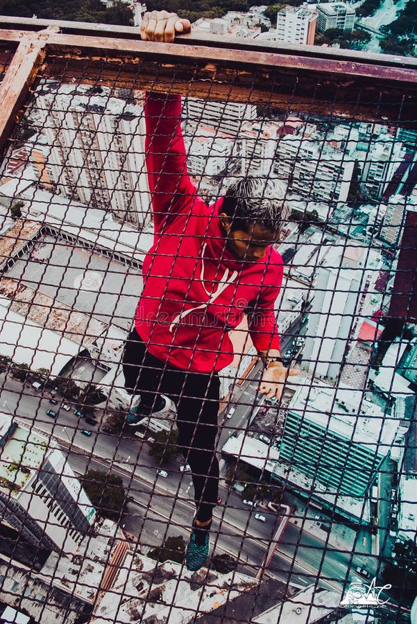 Boy Hanging from a Very Tall Building Editorial Stock Photo - Image of ...