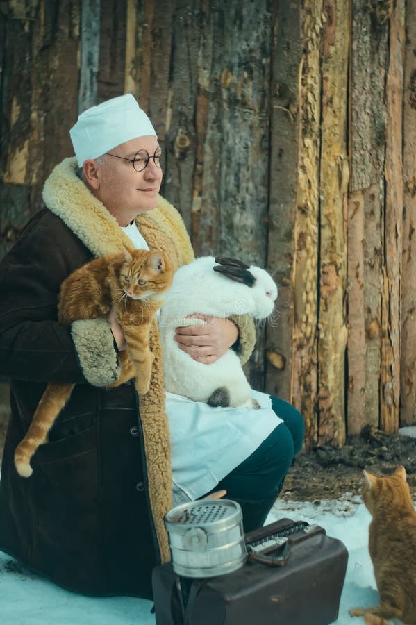 Veterinarian Doctor Holds a Red Cat and a White Rabbit. Stock Image ...