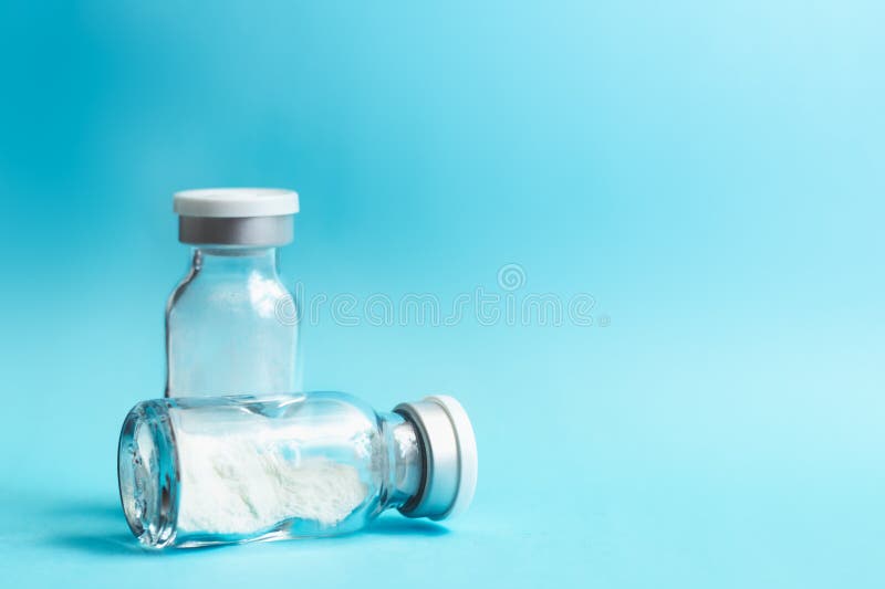 Vials of Medicine in Powder Form on Blue Background, Soft Focus Stock ...