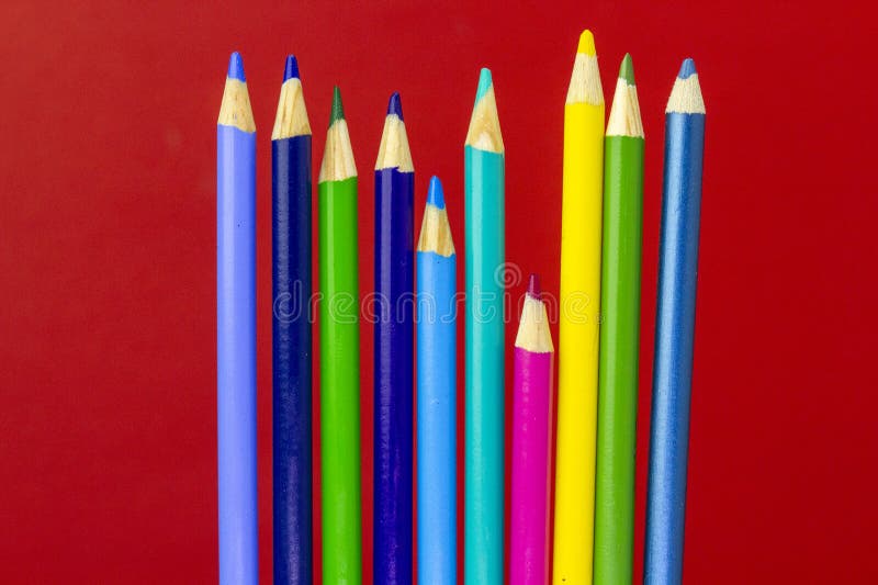 Vibrant Array of Colored Pencils Against a Bold Red Background Stock ...