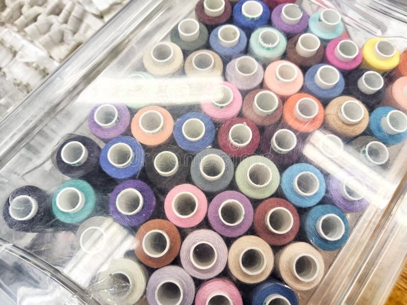Vibrant Array of Thread Spools in a Transparent Storage Box. Colorful ...