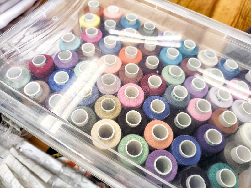 Vibrant Array of Thread Spools in a Transparent Storage Box. Colorful ...