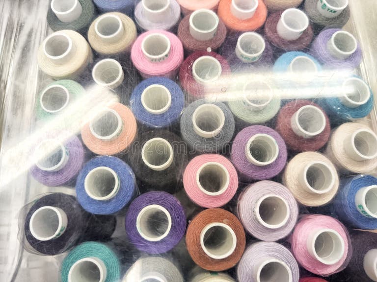 Vibrant Array of Thread Spools in a Transparent Storage Box. Colorful ...