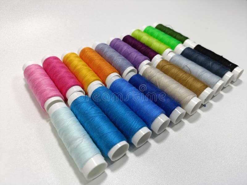 Colorful Sewing Thread Spools Arranged in Rows on White Background ...
